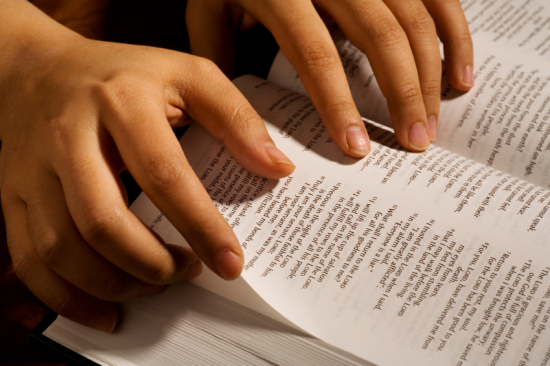 A pair of hands scanning and turning the pages of the Bible. - Urad za ...